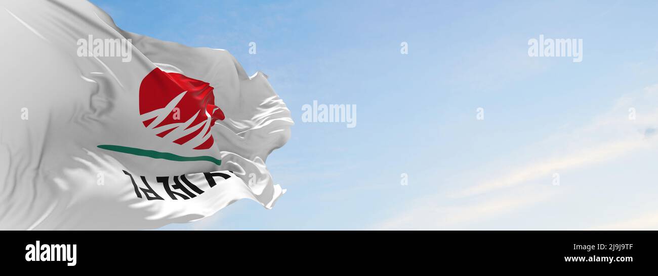 official flag of Gimje city, South Korea at cloudy sky background on sunset, panoramic view ...