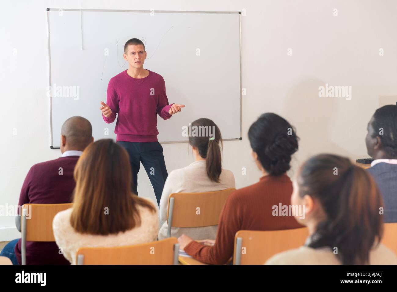 Teacher is giving lecture for students in class Stock Photo - Alamy
