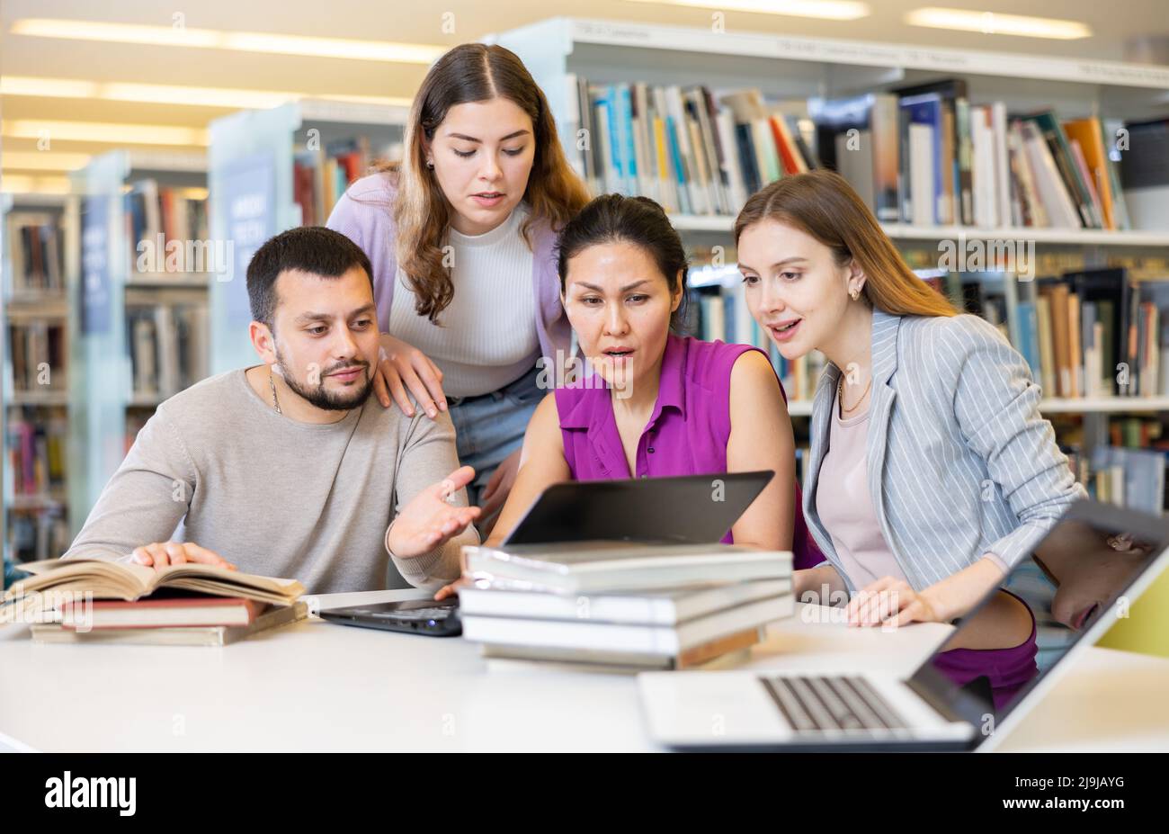 Group portrait of smiling positive engaged in research, working ...