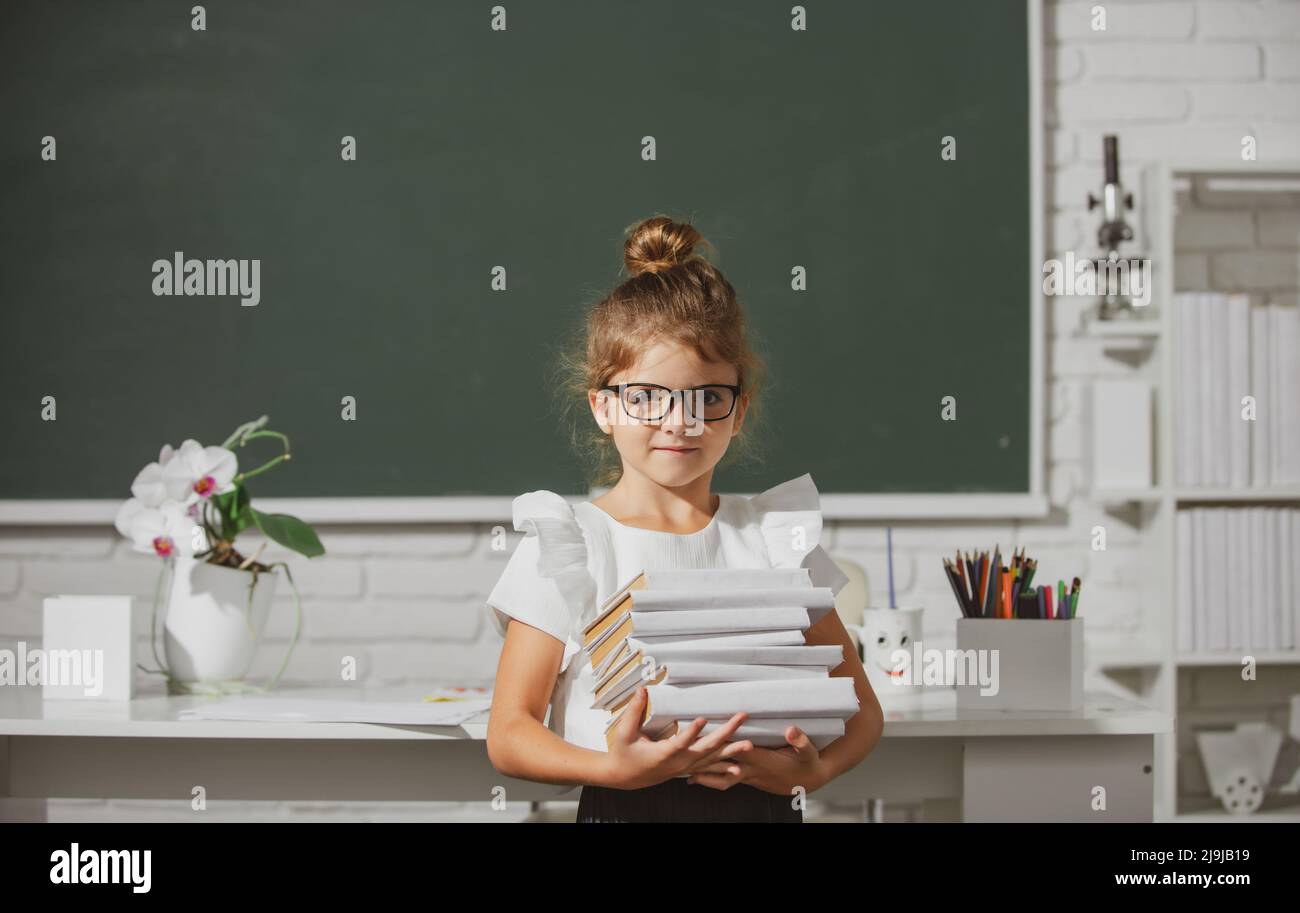 Portrait of cute, lovely, girl in school uniform in classroom. Nerd ...