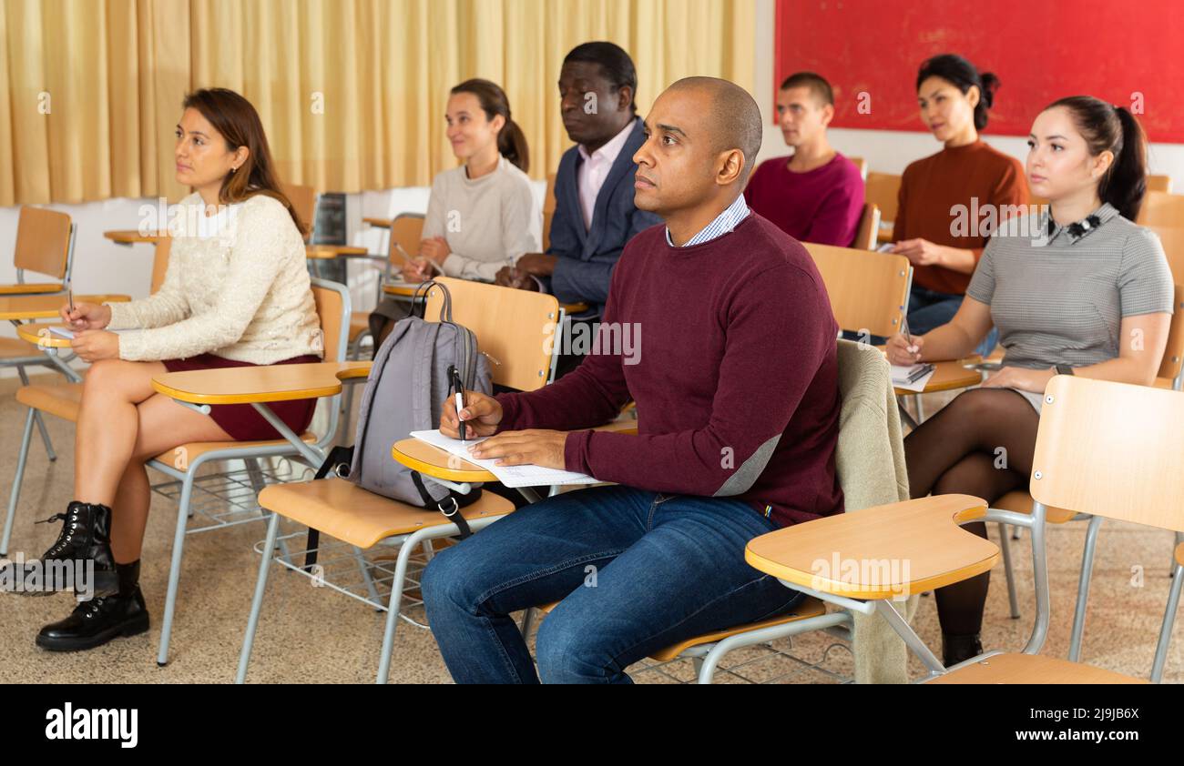 Group of students attentively listening to lecture in classroom Stock ...