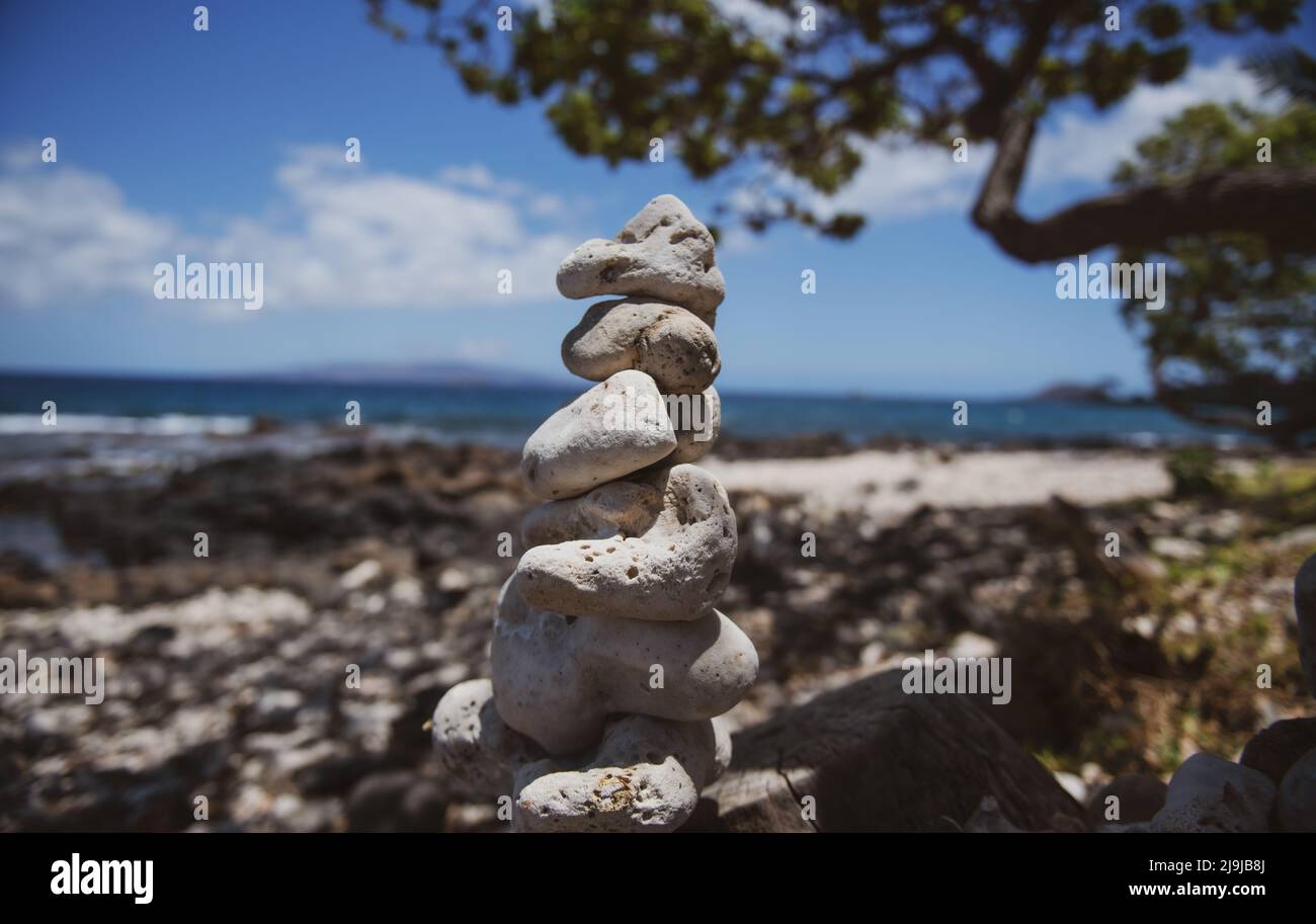 Tower of stones on sea beach background. Relaxing in the tropical beach ...
