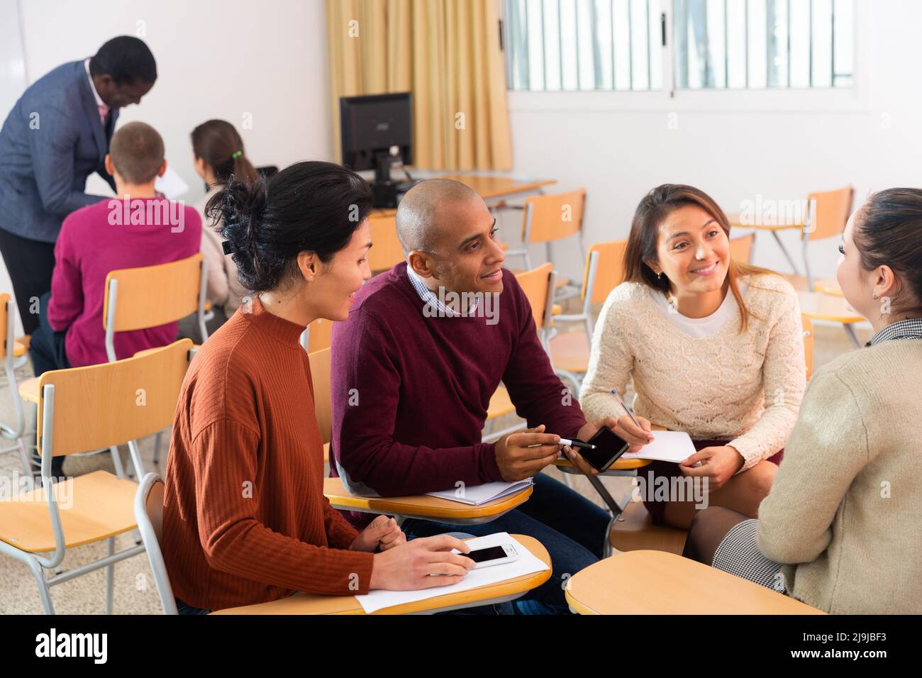 Adult students in cooperation with their school assignment Stock Photo ... Adult students in cooperation with their school assignment Stock Photo ...