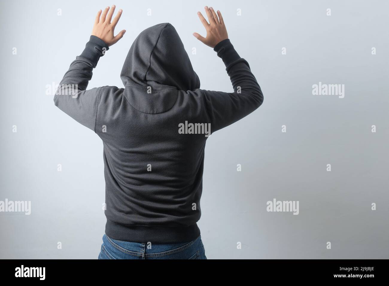 rear view mysterious man with surrender gesture Stock Photo - Alamy