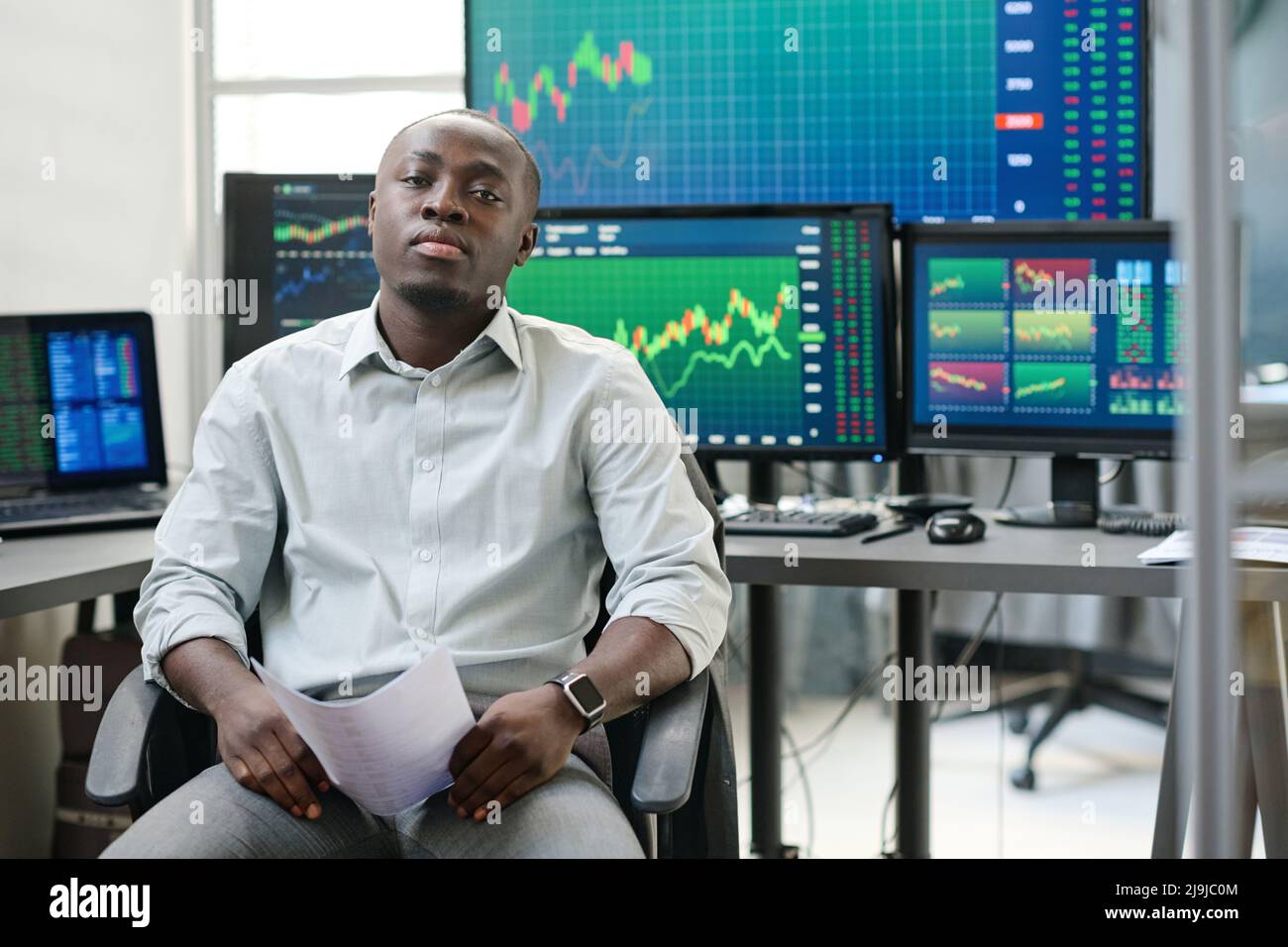 Professional African American stock trading advisor sitting on chair ...