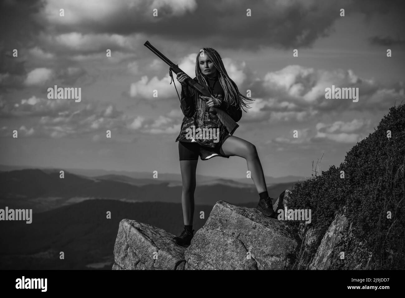 Hunter woman holding gun and walking in forest. Hunter Education Course ...