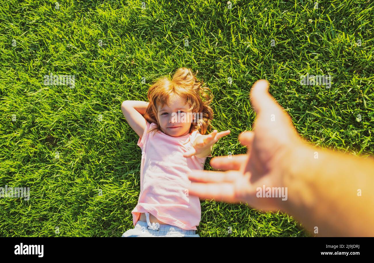 Kid pull father hand. Follow me, hand-in-hand walking on bright sunny ...