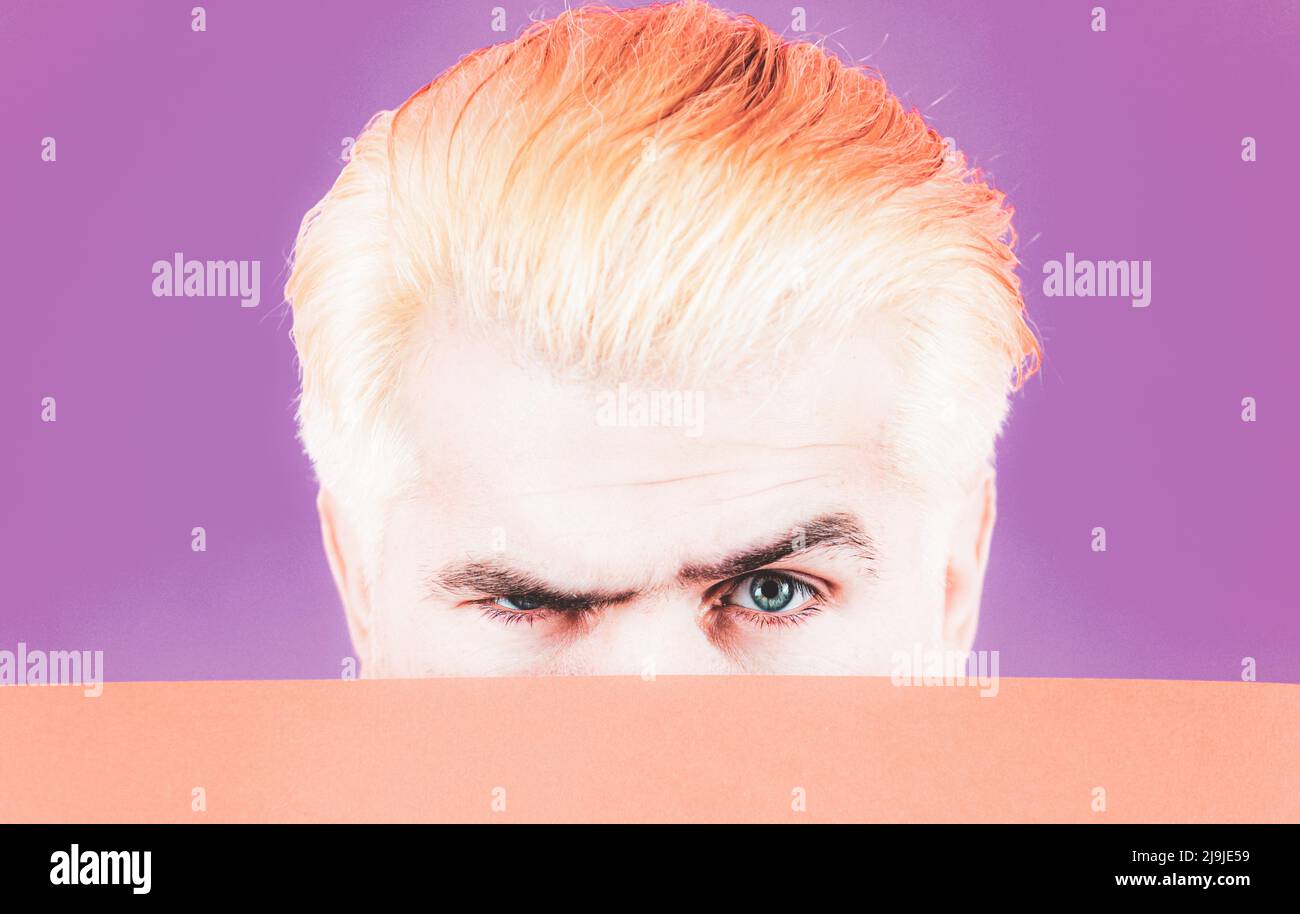 Eyes close up. Man with blank advertising board on color background ...