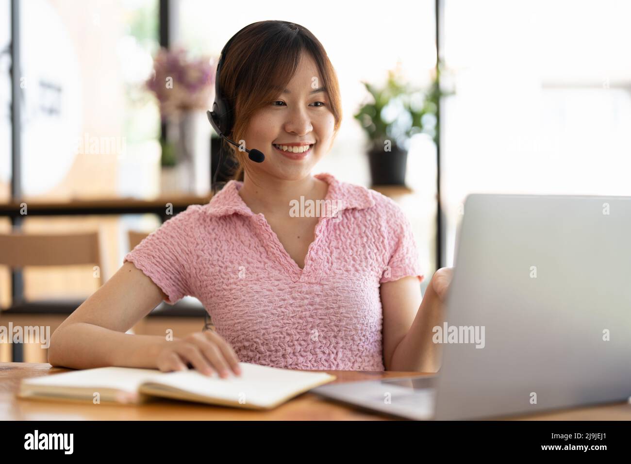 Smiling girl student wear wireless headphone study online with teacher ...