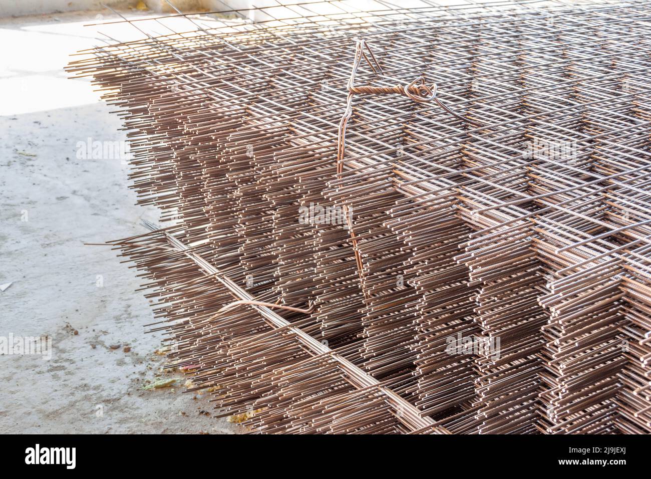 rusty new reinforcing mesh made of thin corrugated steel bar stacked in ...