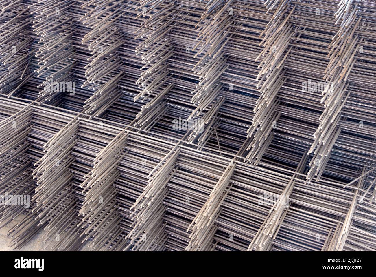 frame mesh of thin corrugated rod stacked vertically, selective focus ...