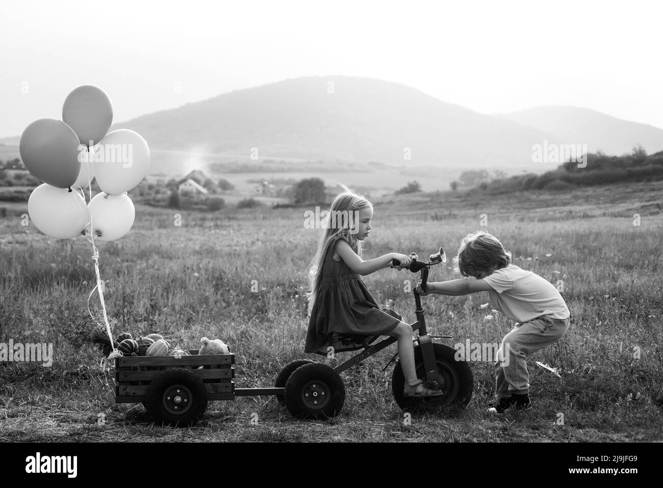 Son and daughter planting on ground. Eco living. Eco farm for kids. Two ...