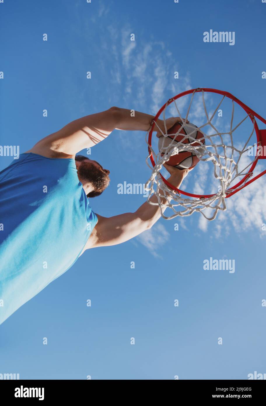 Basketball player shooting ball in hoop outdoor court. Urban youth game ...