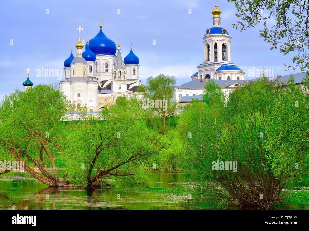 Domes of the Bogolyubov Monastery. The monastery pond in spring, the ...