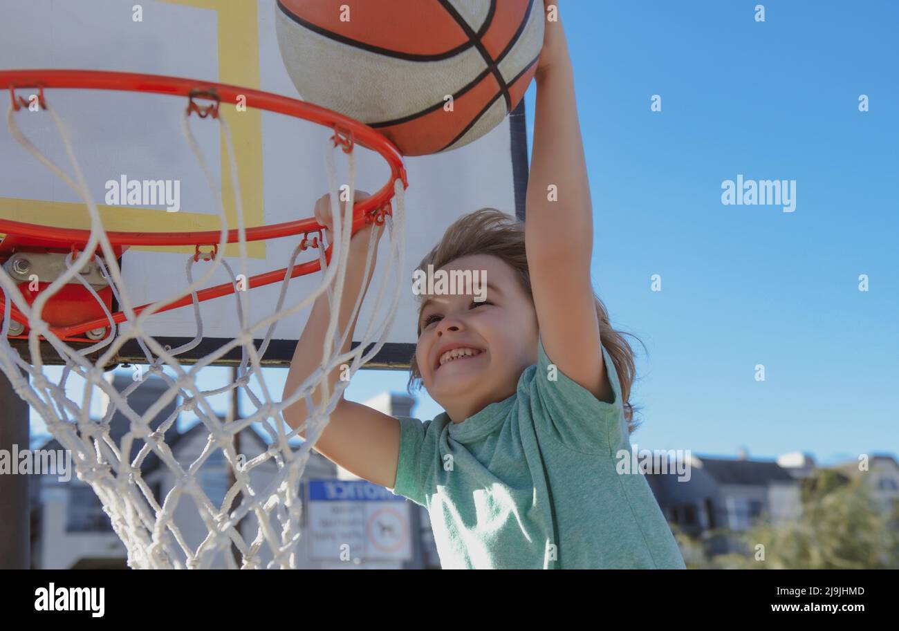 Kid boy basketball player with a ball scoring a goal. Child Player ...