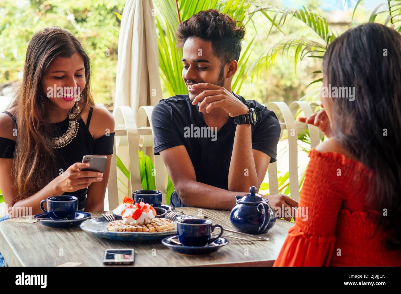 Indian woman eating chocolate hi-res stock photography and images - Alamy