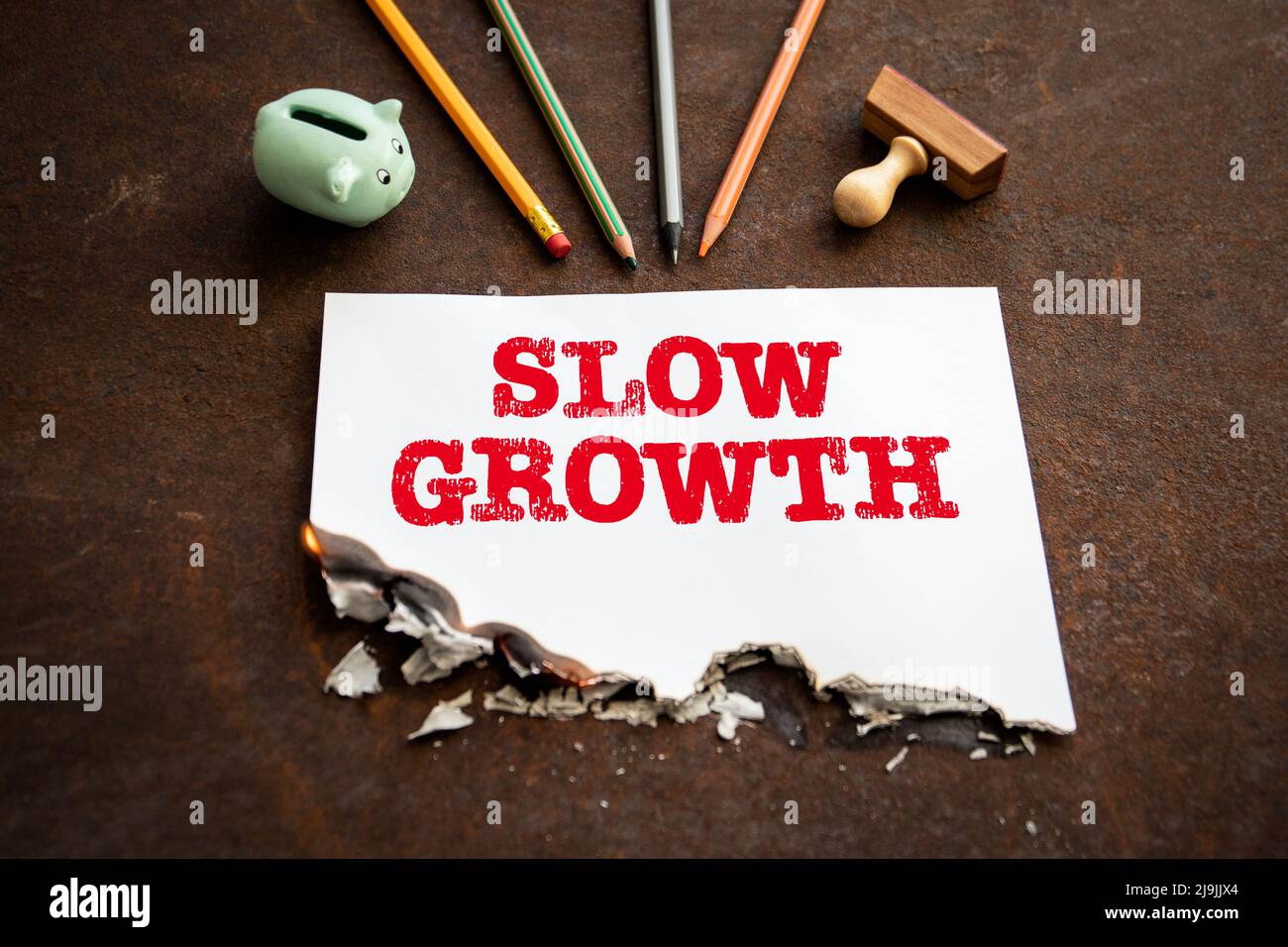 SLOW GROWTH. Economy and business concept. Rusty metal background Stock ...