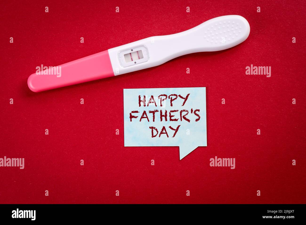 Happy father's day. Pregnancy test and speech bubble on a red ...