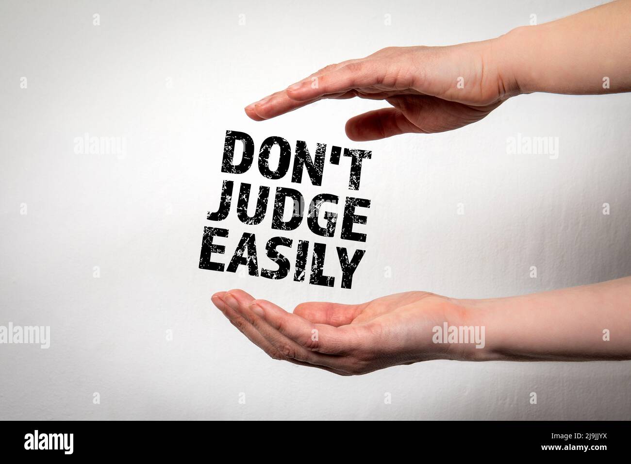 Do Not Judge Easily. Woman's hands and text on a white background Stock Photo - Alamy