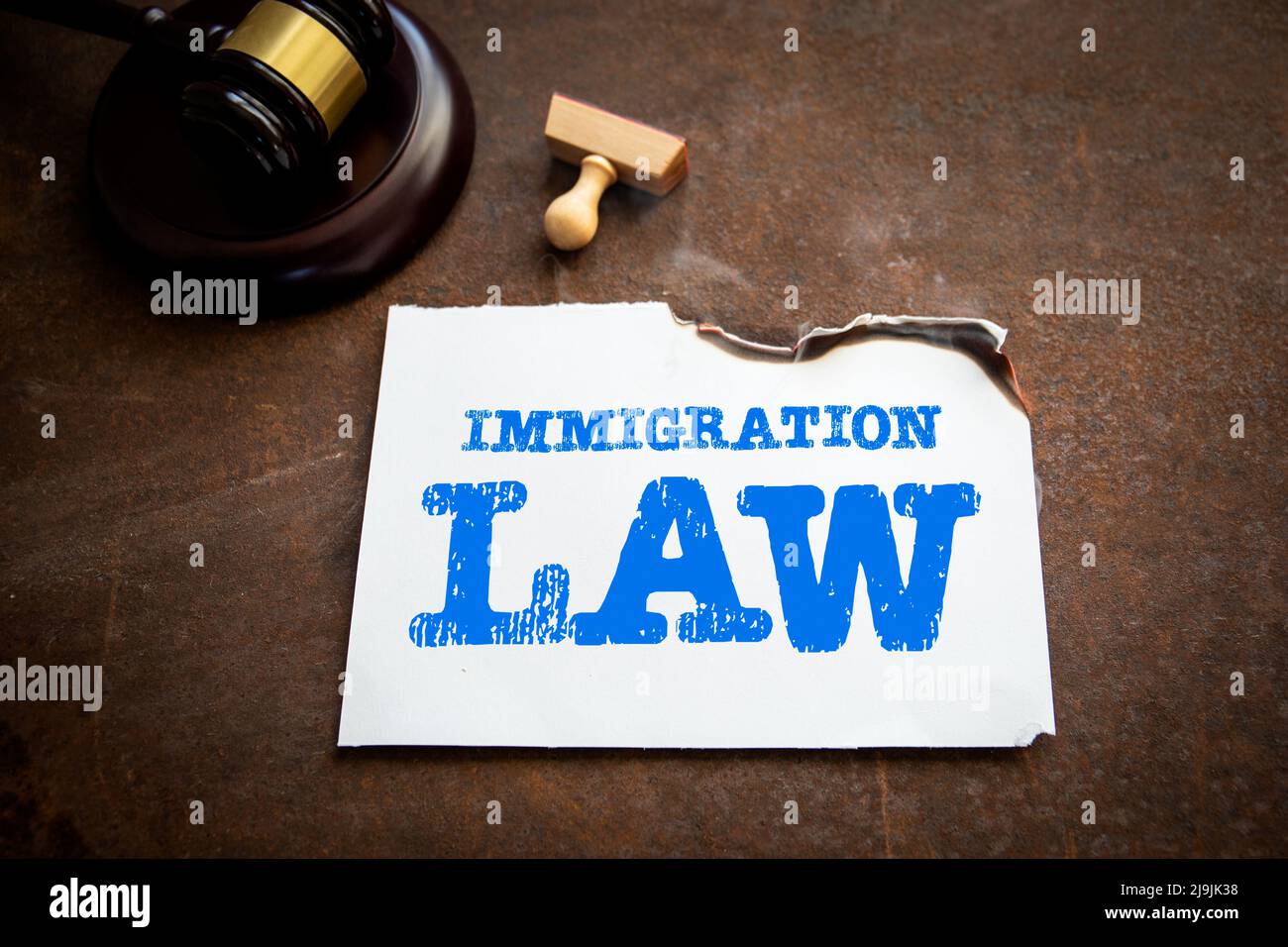 IMMIGRATION LAW. Sheet of paper and a judge's hammer on a rusty metal ...