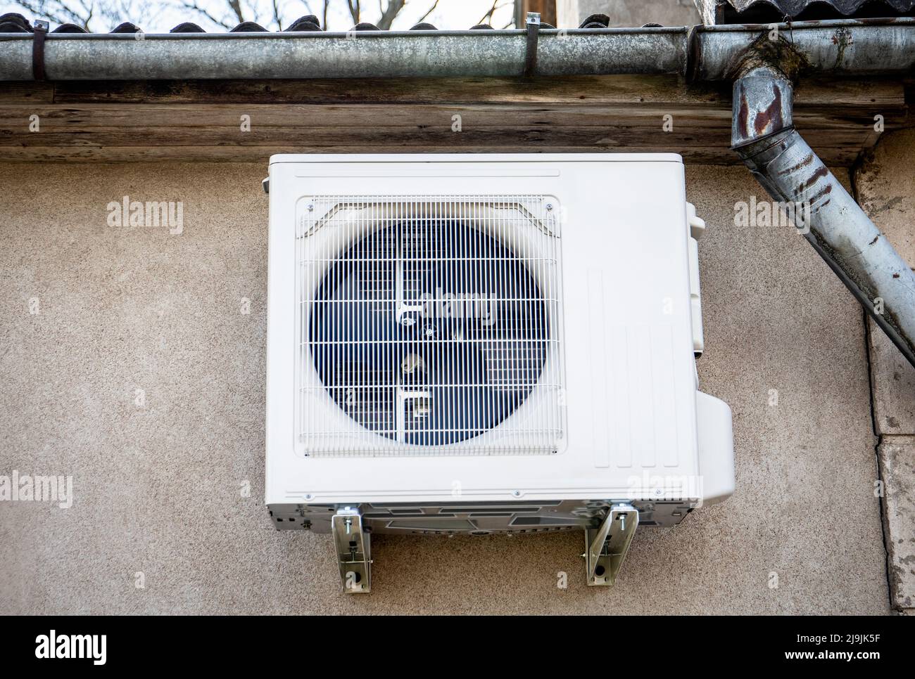 Air source heat pump, outdoor unit attached to the house wall Stock ...