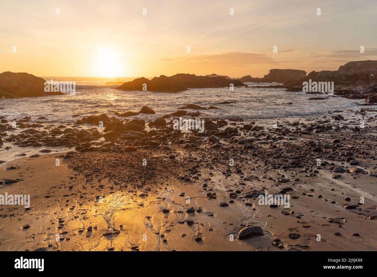 warm sunset over receding tide of the pacific ocean Stock Photo - Alamy