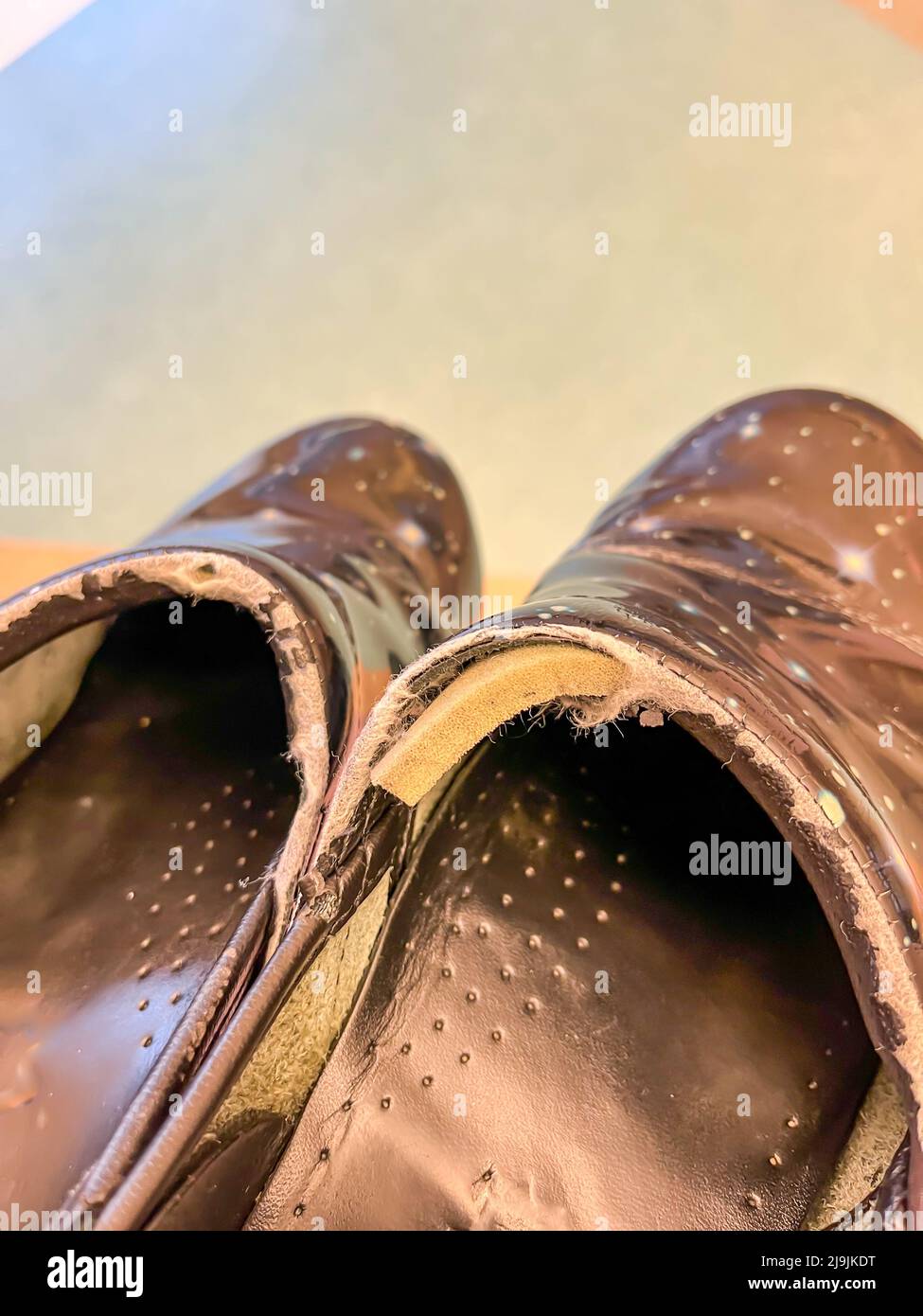 Worn out and damaged slip-on shoes with frayed binding Stock Photo - Alamy