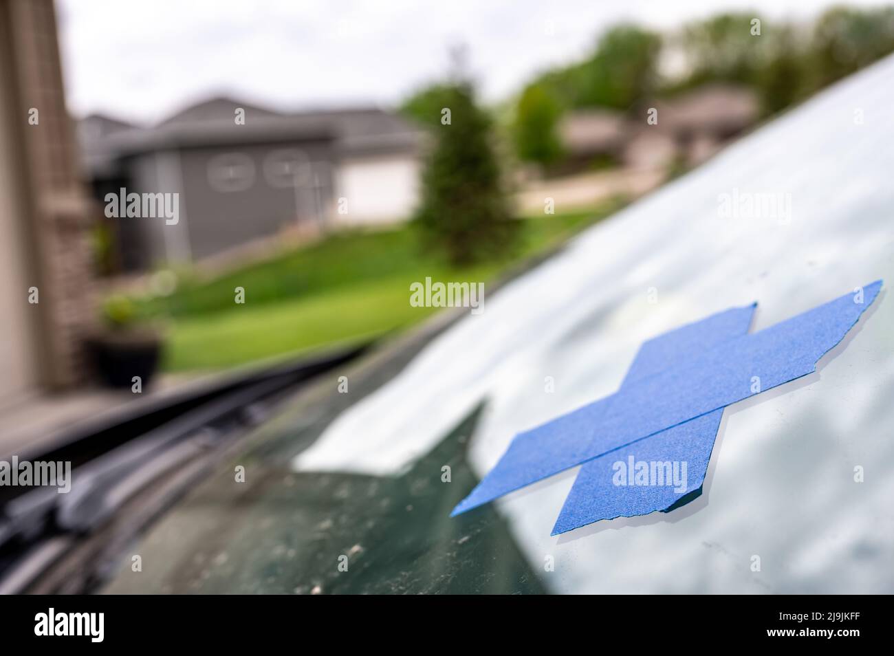 Tape covering a chip on a car windshield Stock Photo - Alamy