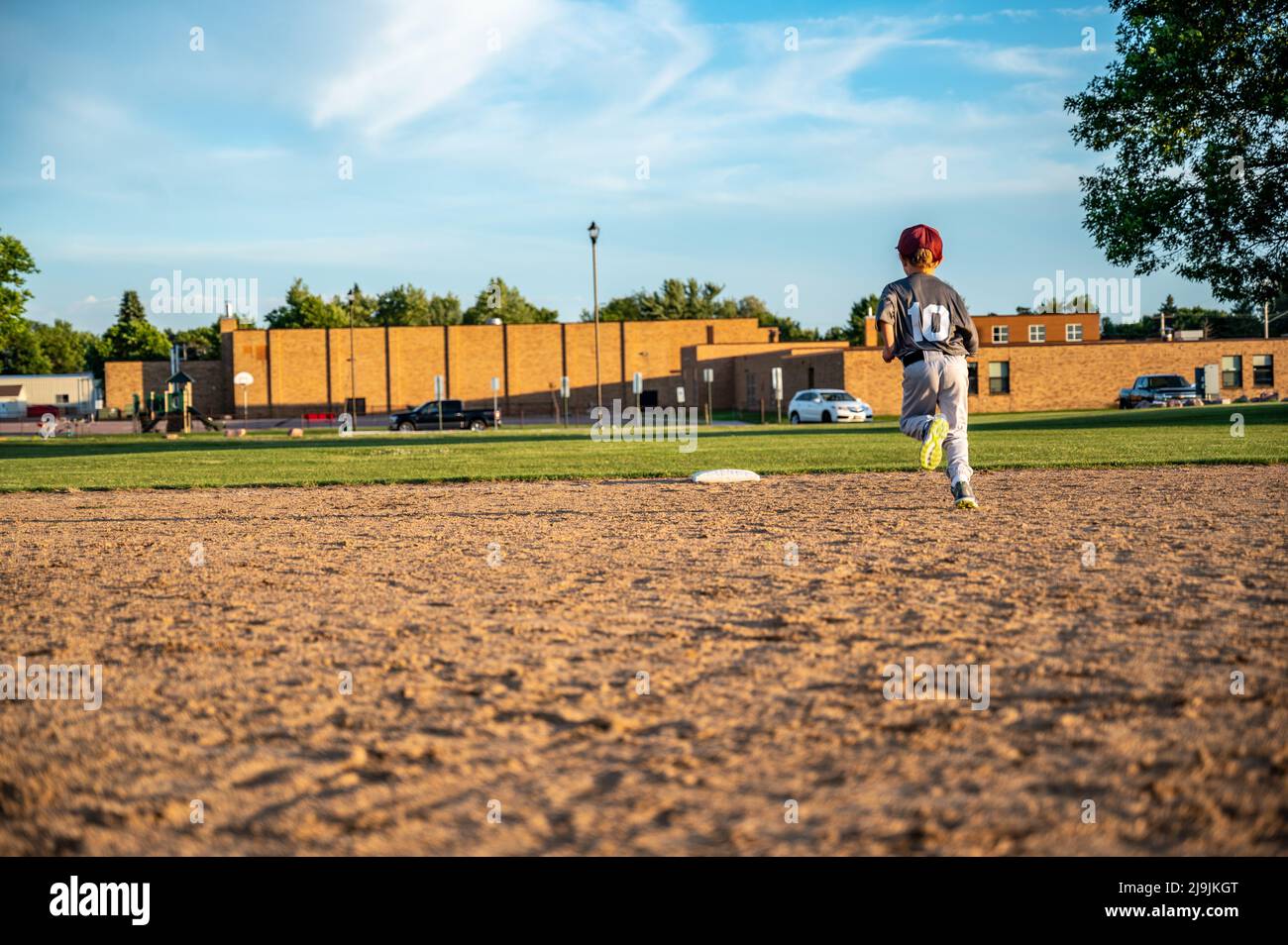 Male youth running bases after hitting the baseball Stock Photo - Alamy
