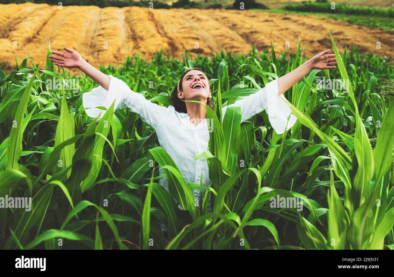 Cheerful woman posing in the corn crop, agriculture and cultivation ...