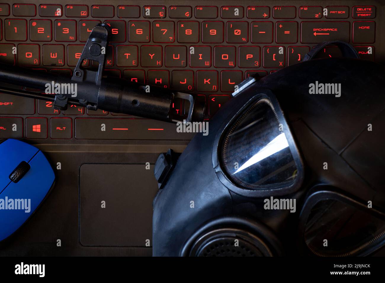 Military Machine Gun And Computer Mouse And Black Gas Mask Lie On The