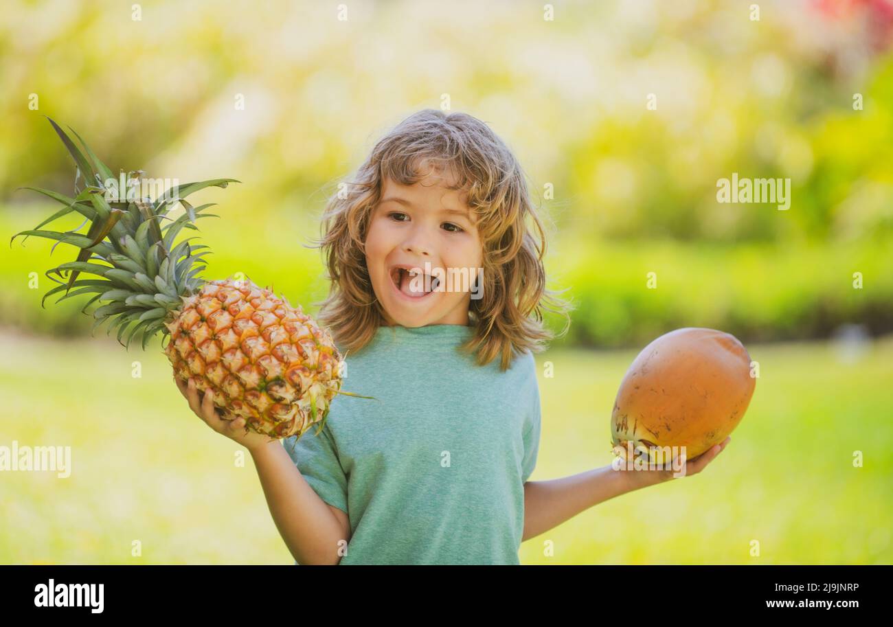 Little boy with pineapple and coconut. Kid with summer fruit Stock ...