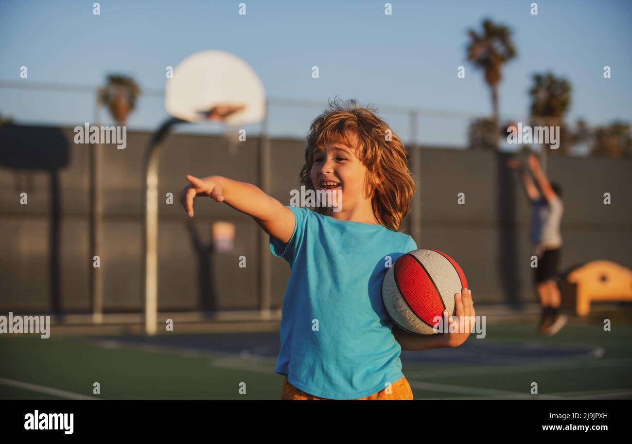 Basketball game. Kid training with basket ball on basketball court ...