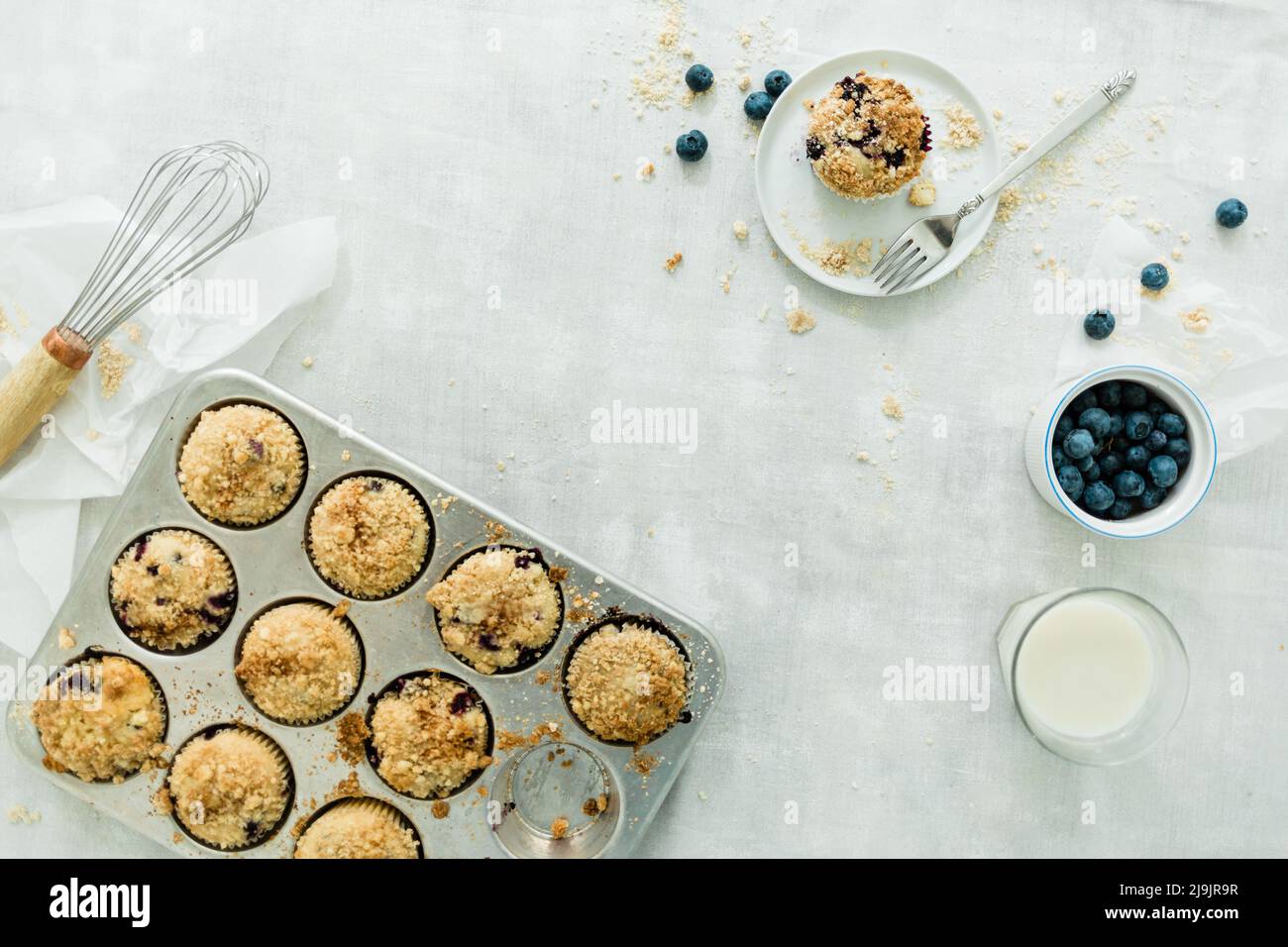 Blueberry muffins on a marble background with cooking utensils and ...