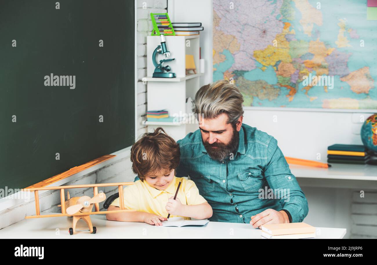 Father teaching son. Learning concept. Pupil learning letters and ...