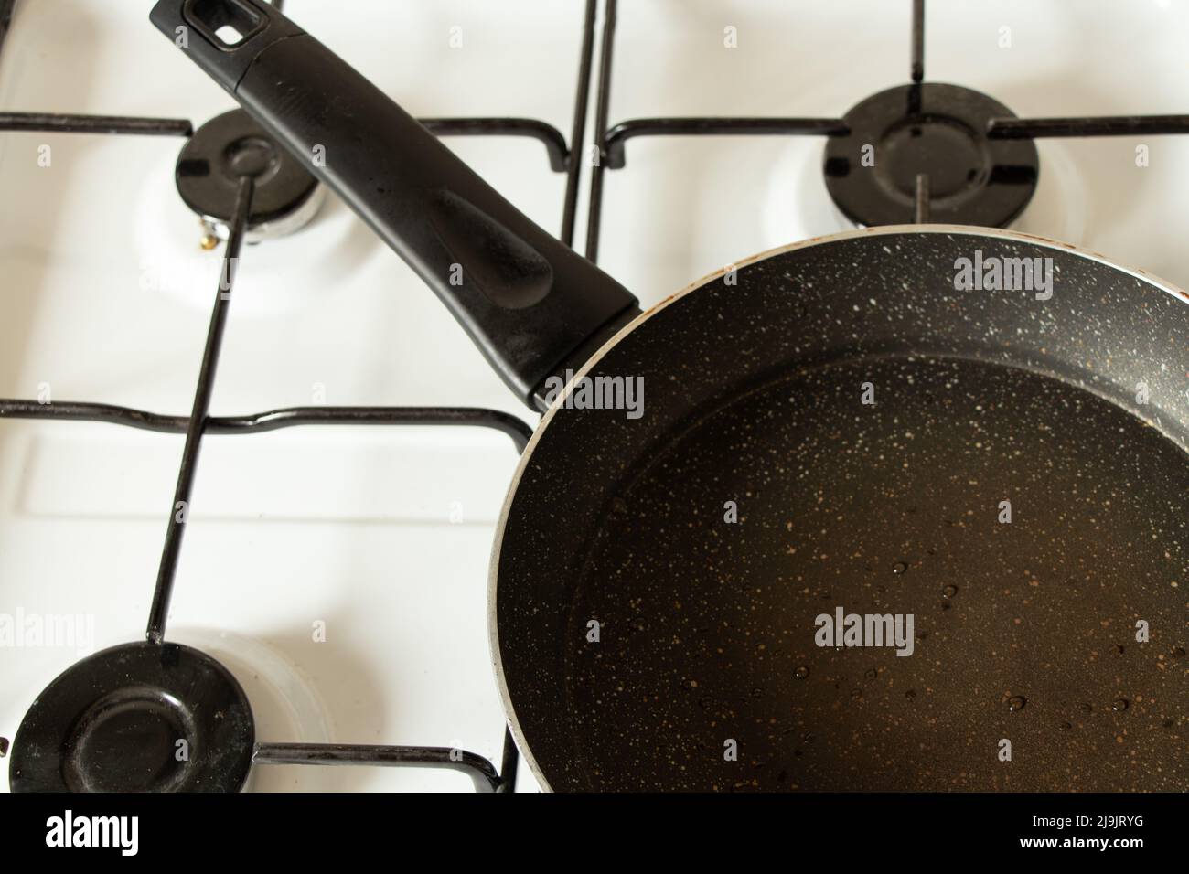 A frying pan stands on a gas stove at home in the kitchen, kitchen ...