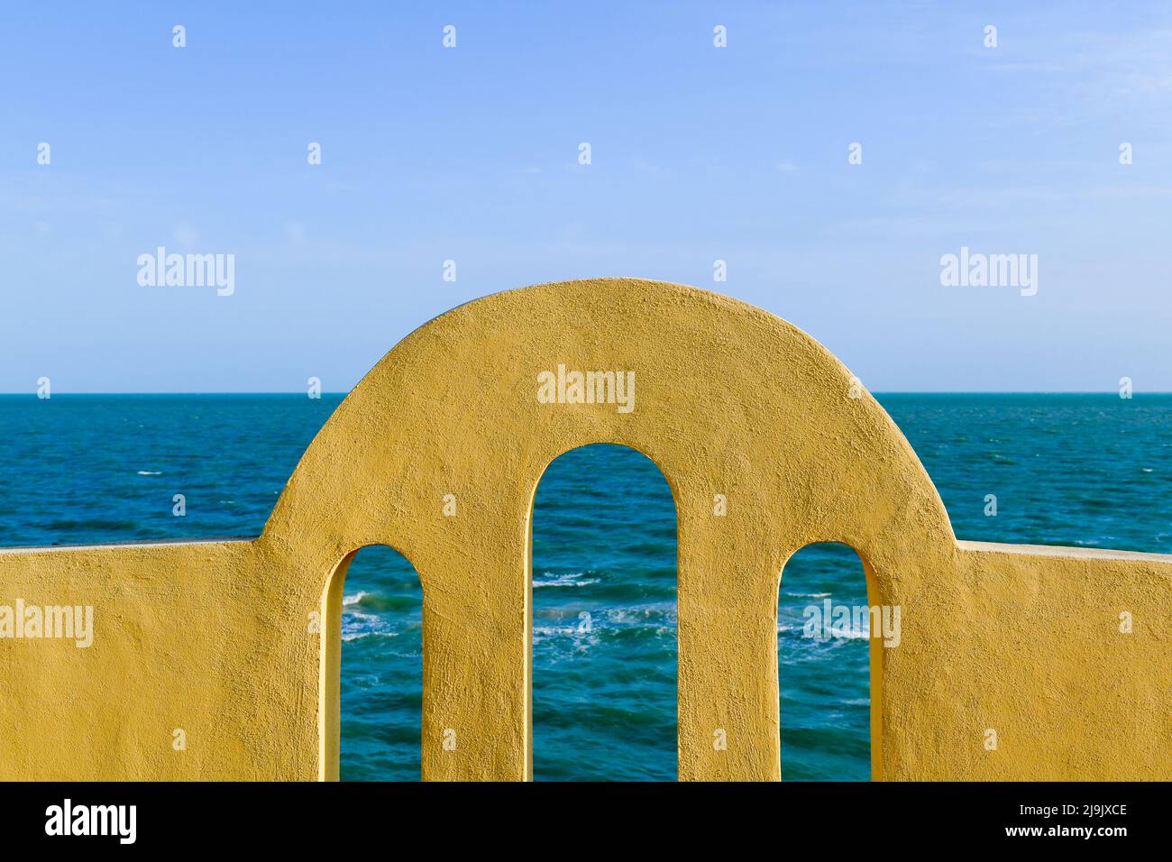 Yellow wall and ocean Stock Photo - Alamy