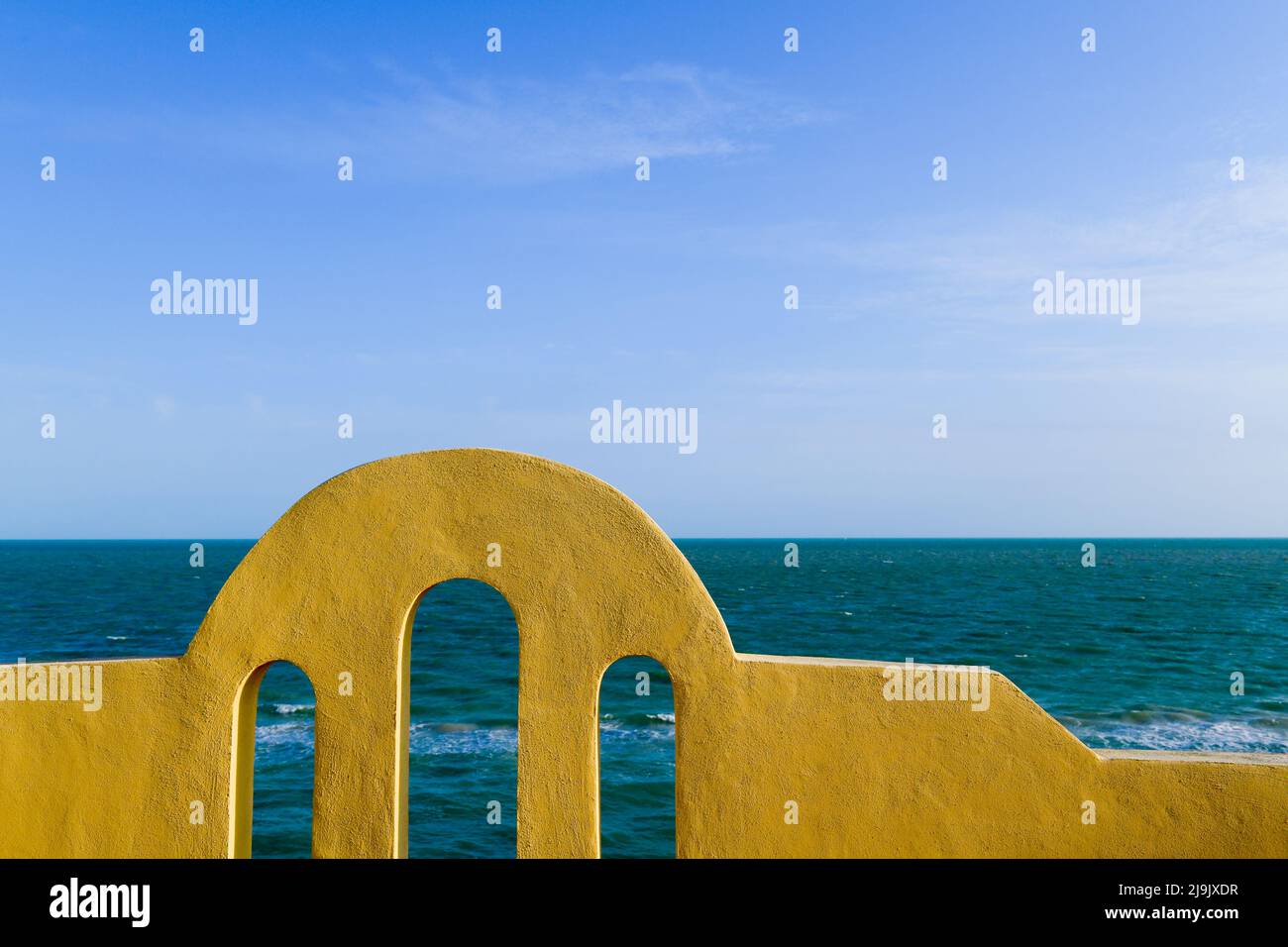 Yellow wall and ocean Stock Photo - Alamy