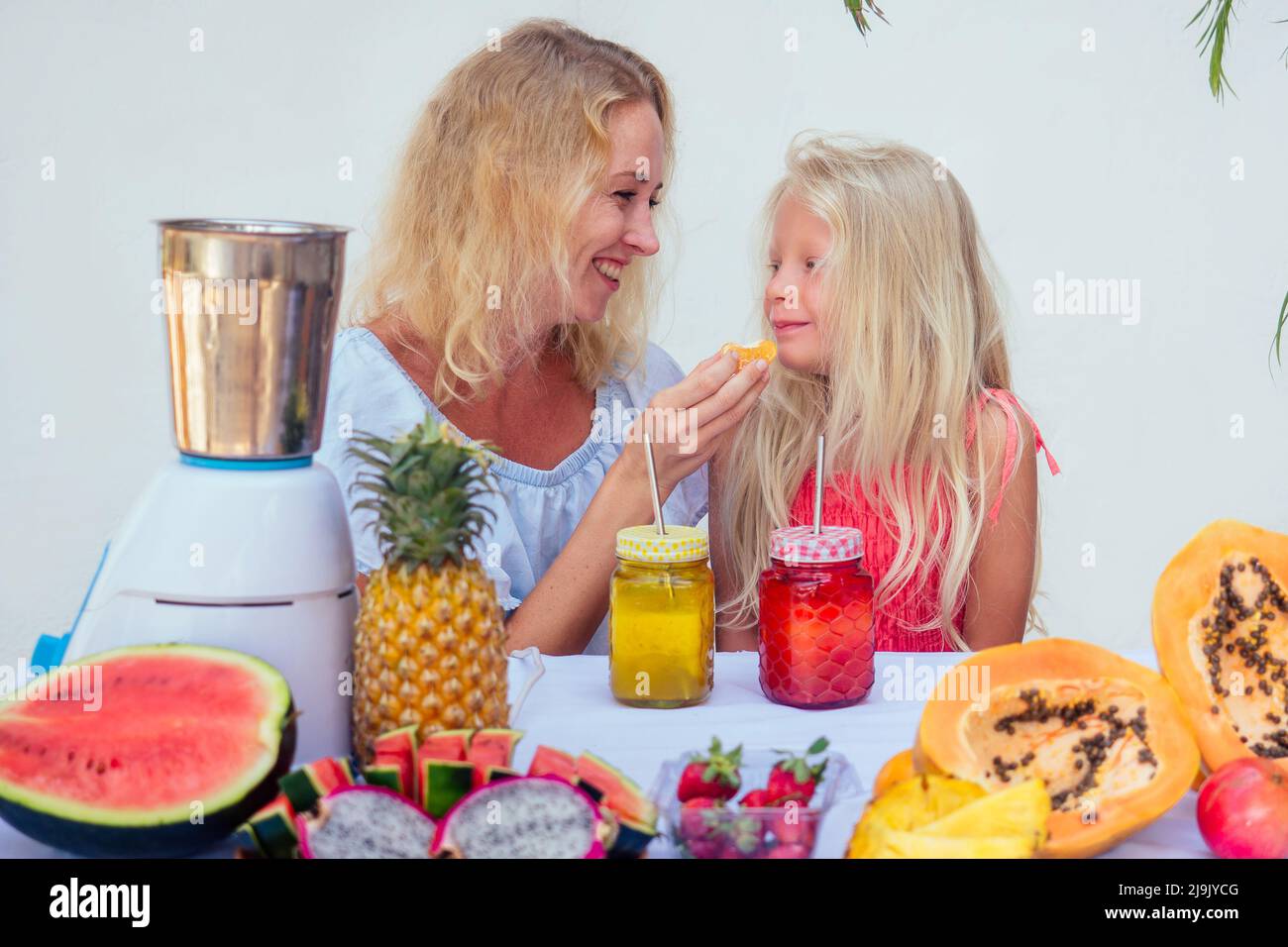 caucasian family in the kitchen during breakfast at home. two blonde ...