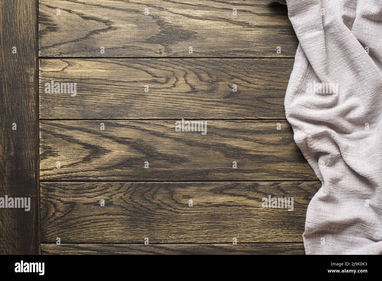 Sand color tablecloth on oak wooden table top view with copy space ...