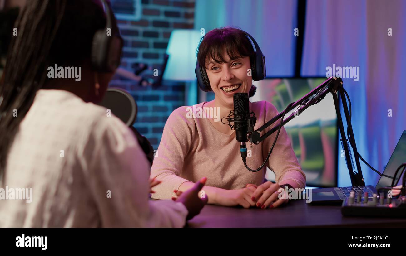 Closeup of online radio host recording interview with african american ...