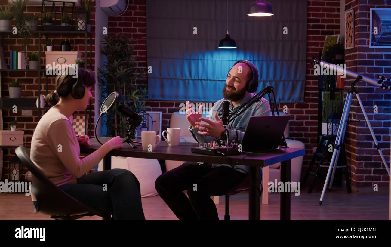 Man and woman talking in online podcast using professional recording ...