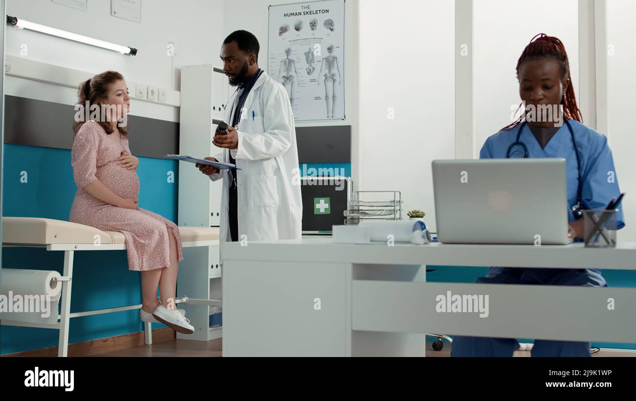 Doctor giving patient documents hi-res stock photography and images - Alamy