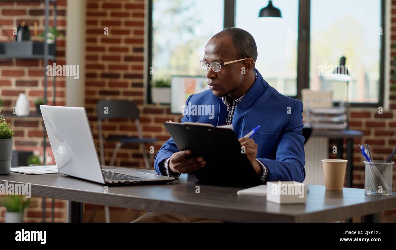 Project manager analyzing statistics plan with application report on ...