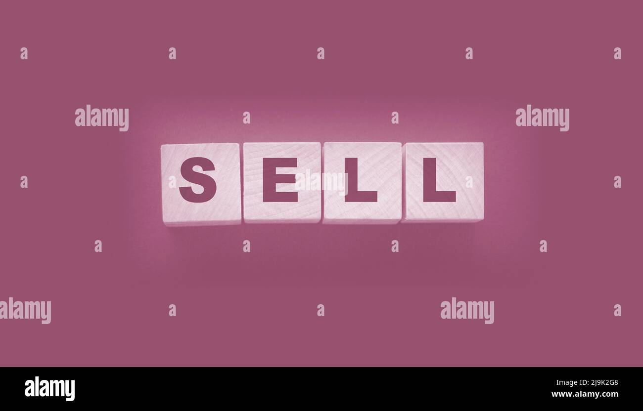 Wooden cubes with word sell on the dark background. Shopping concept ...