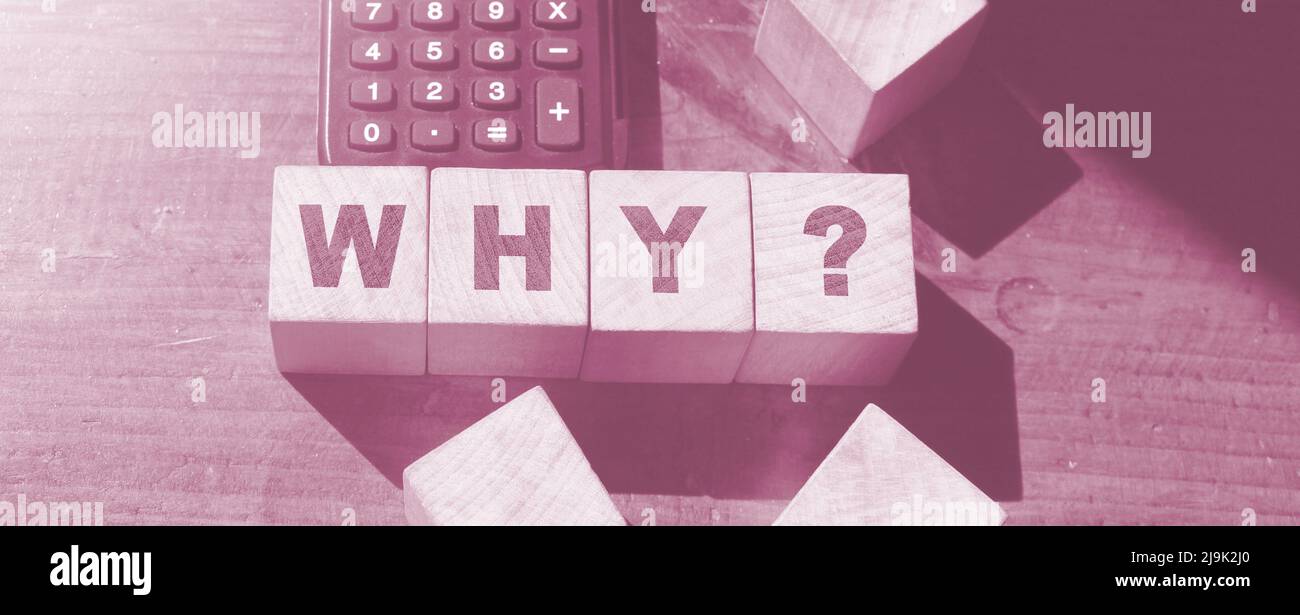 The word Why with quetion mark on wooden Blocks and calculator ...