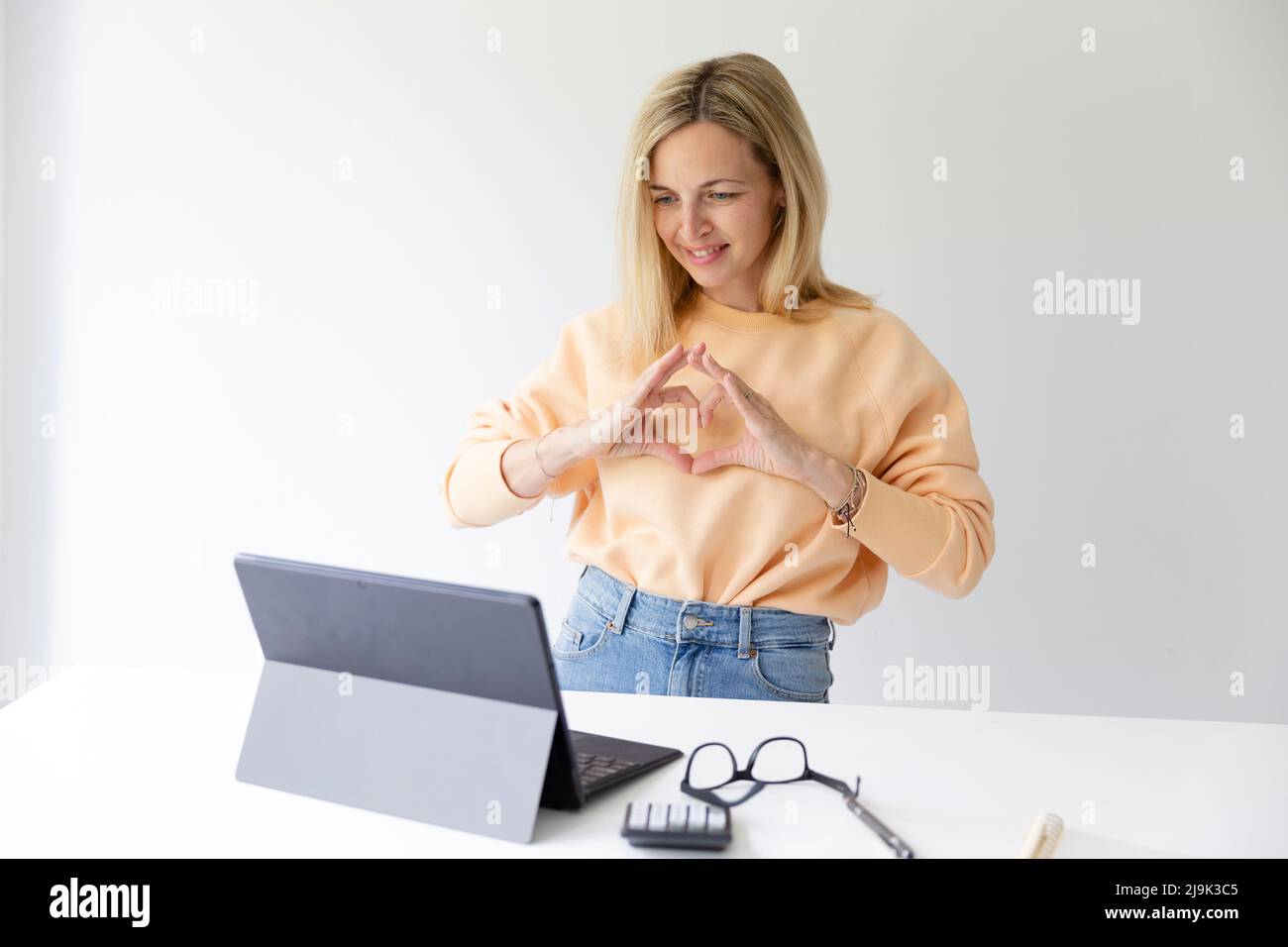 pretty young blonde woman with beautiful laugh stands by height ... pretty young blonde woman with beautiful laugh stands by height ...