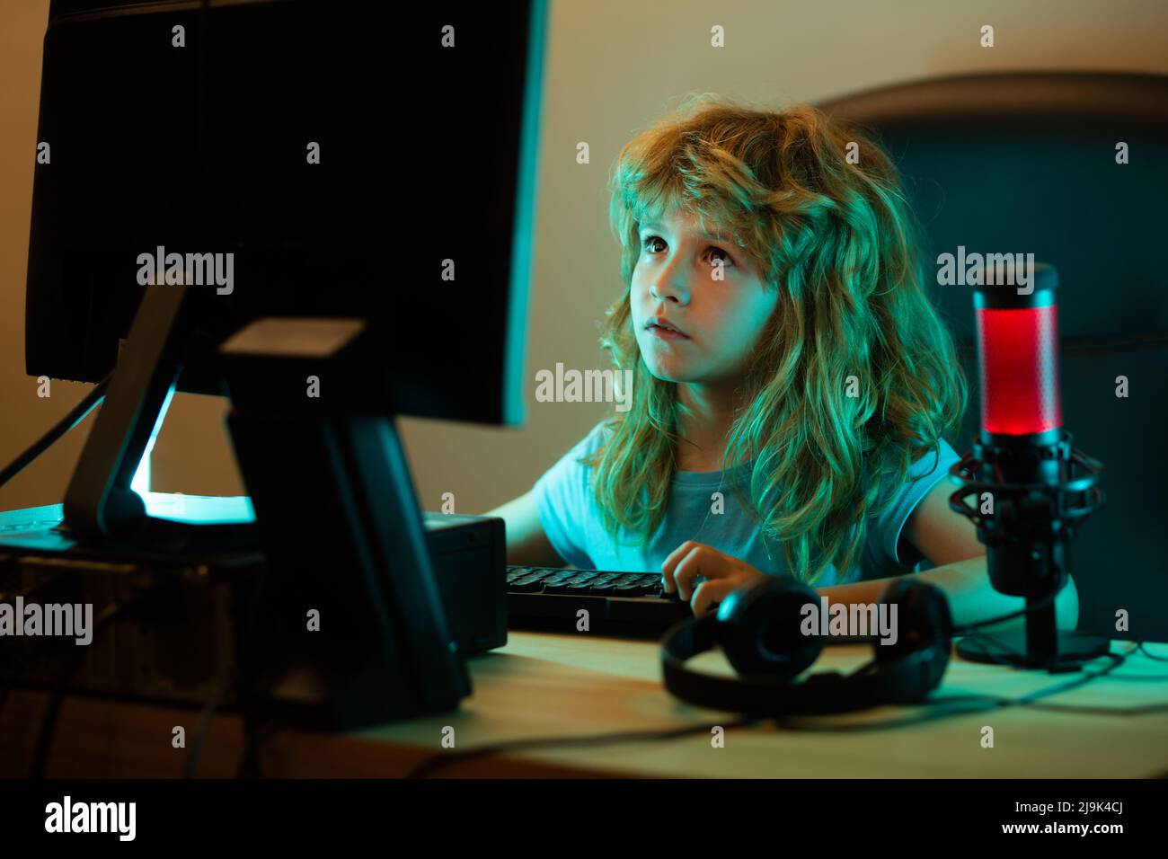 Child playing computer games or studying on pc computer. Kid gamer on ...