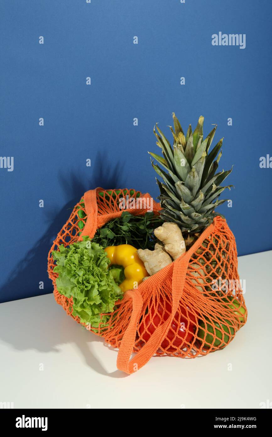 String bag with vegetables and fruits on two tone background Stock ...