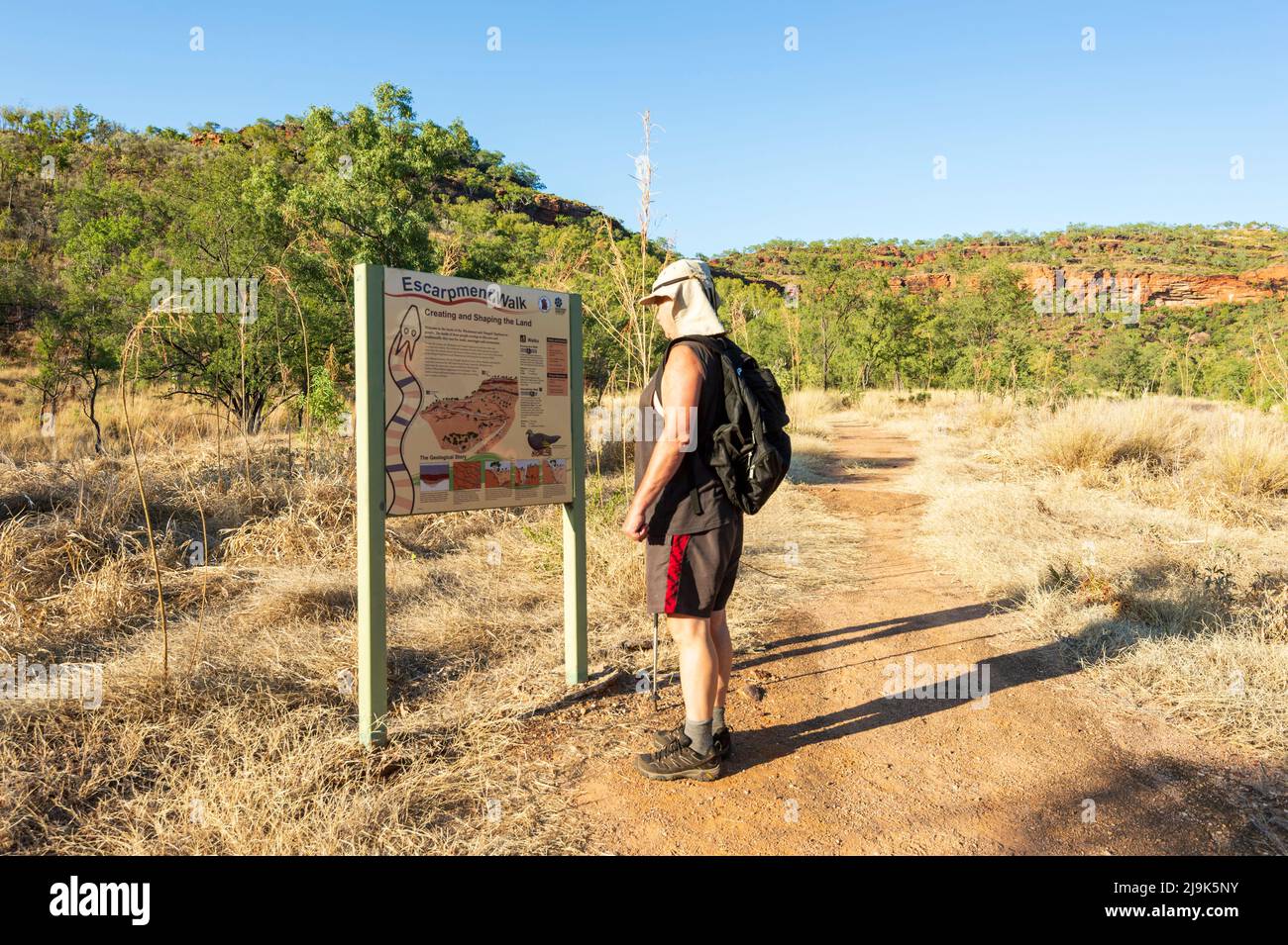 Tourist reading the information sign for the Escarpment Walk, Gregory ...